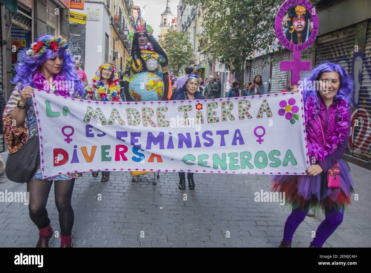 women seen with a banner that says, mother land its feminist, generous ...