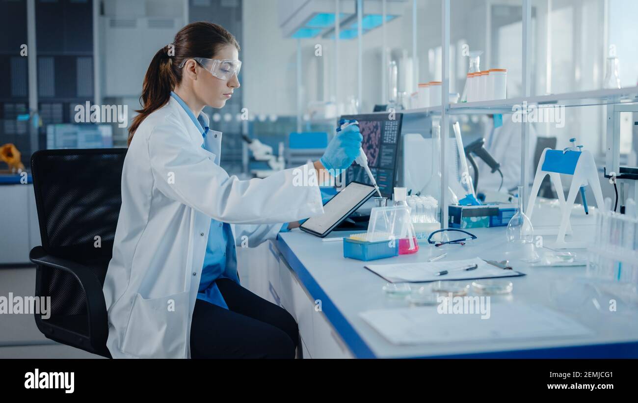 Modern Medical Research Laboratory: Female Scientist Working with Micro ...