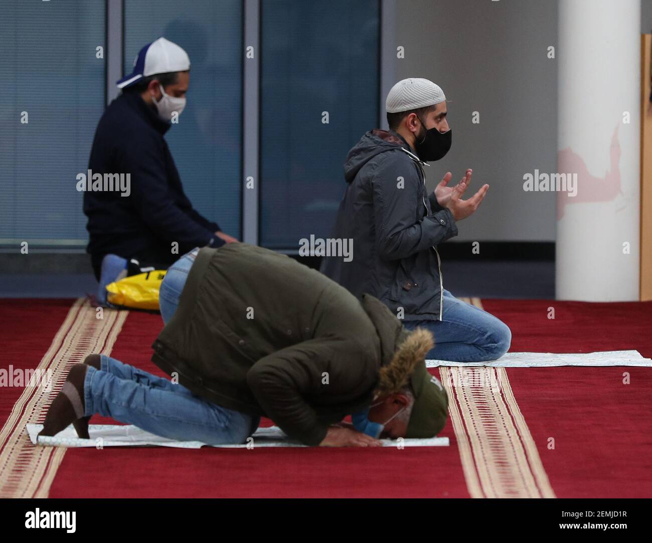 Members of the Muslim community in Oldham take part in a prayer service ...