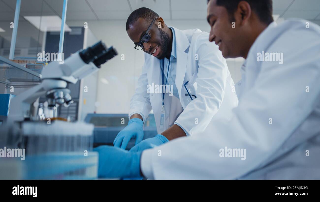 Modern Medical Research Laboratory: Two Smiling Male Scientists Working ...