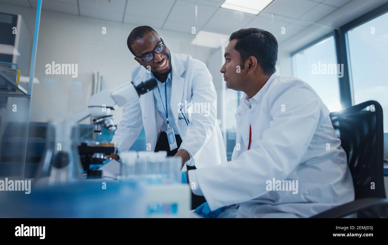 Modern Medical Research Laboratory: Two Smiling Male Scientists Working ...