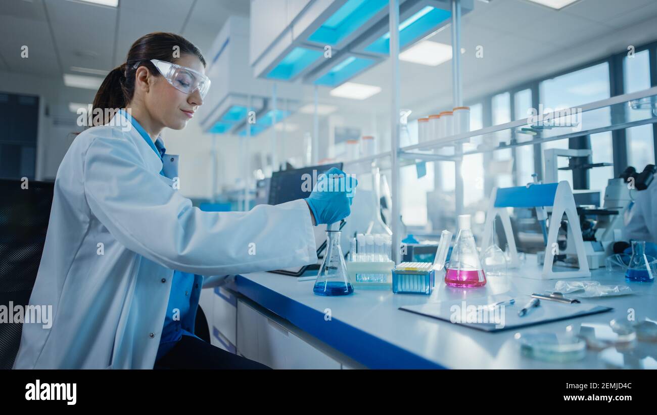 Modern Medical Research Laboratory: Female Scientist Working with Micro ...