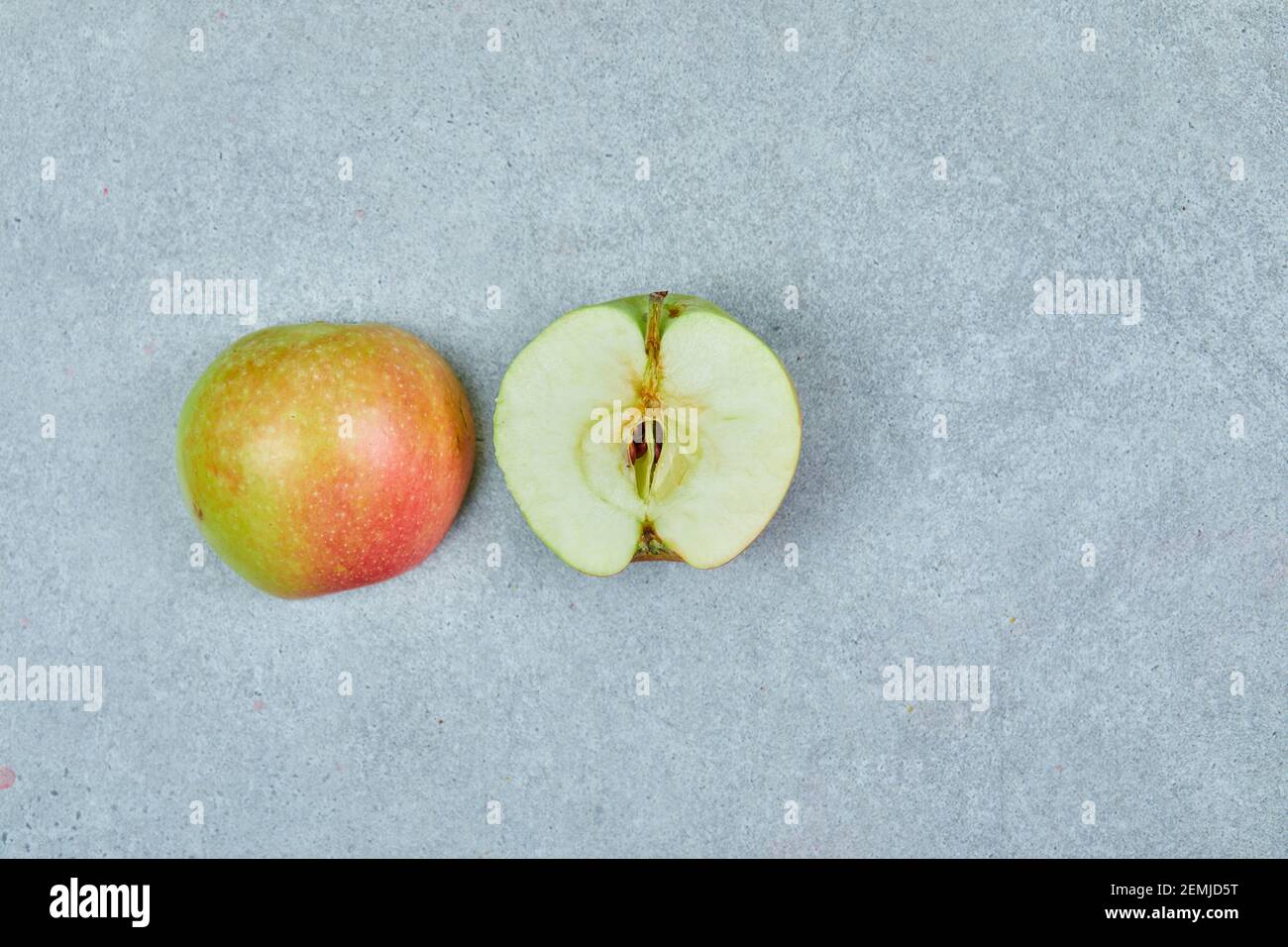 Fresh half cut apple on the grey background Stock Photo - Alamy