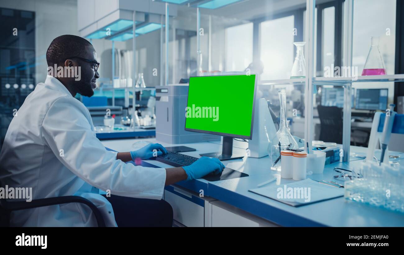 Modern Medical Research Laboratory: Scientist working on Computer ...