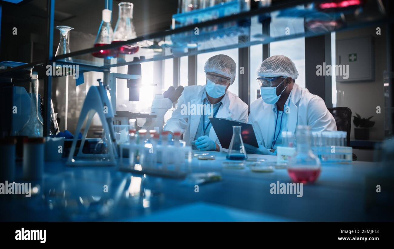 Modern Medical Research Laboratory: Two Scientists Wearing Face Masks ...