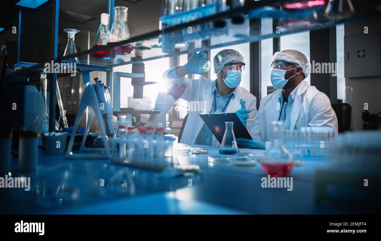 Modern Medical Research Laboratory: Two Scientists Wearing Face Masks ...