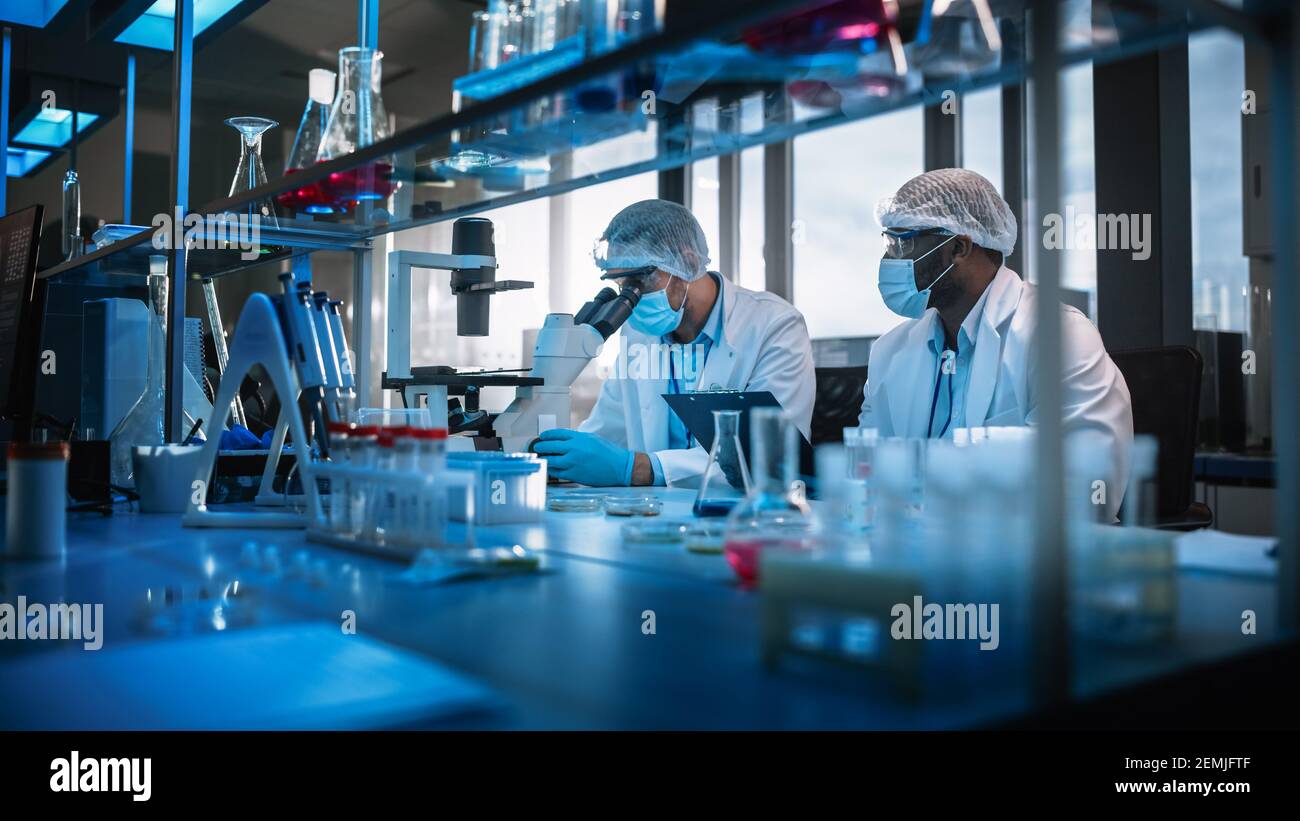 Modern Medical Research Laboratory: Two Scientists Wearing Face Masks ...