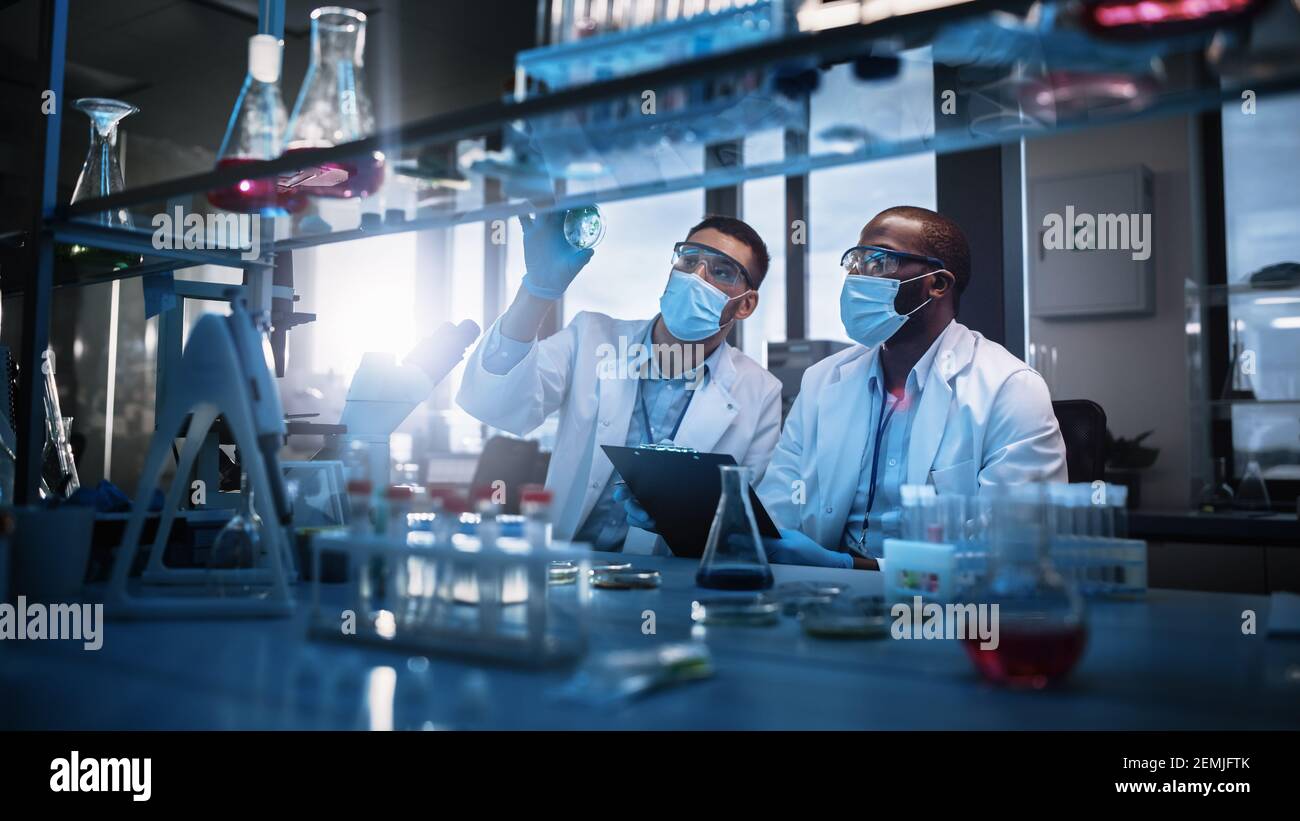 Modern Medical Research Laboratory: Two Scientists Wearing Face Masks ...
