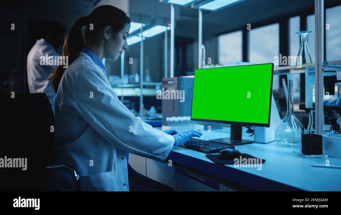 Modern Medical Research Laboratory: Portrait of Female Scientist working on Computer Showing ...