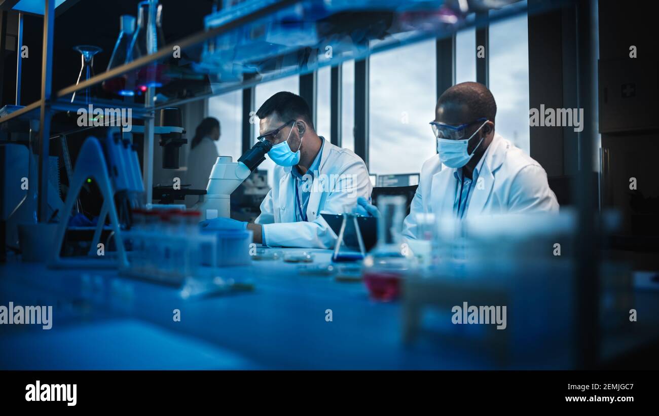 Modern Medical Research Laboratory: Two Scientists Wearing Face Masks ...