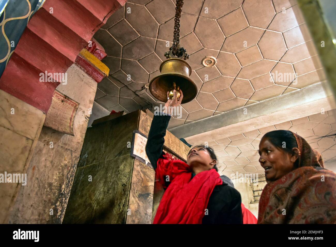 A Hindu devotee seen ringing the bell as she attend the rituals during ...