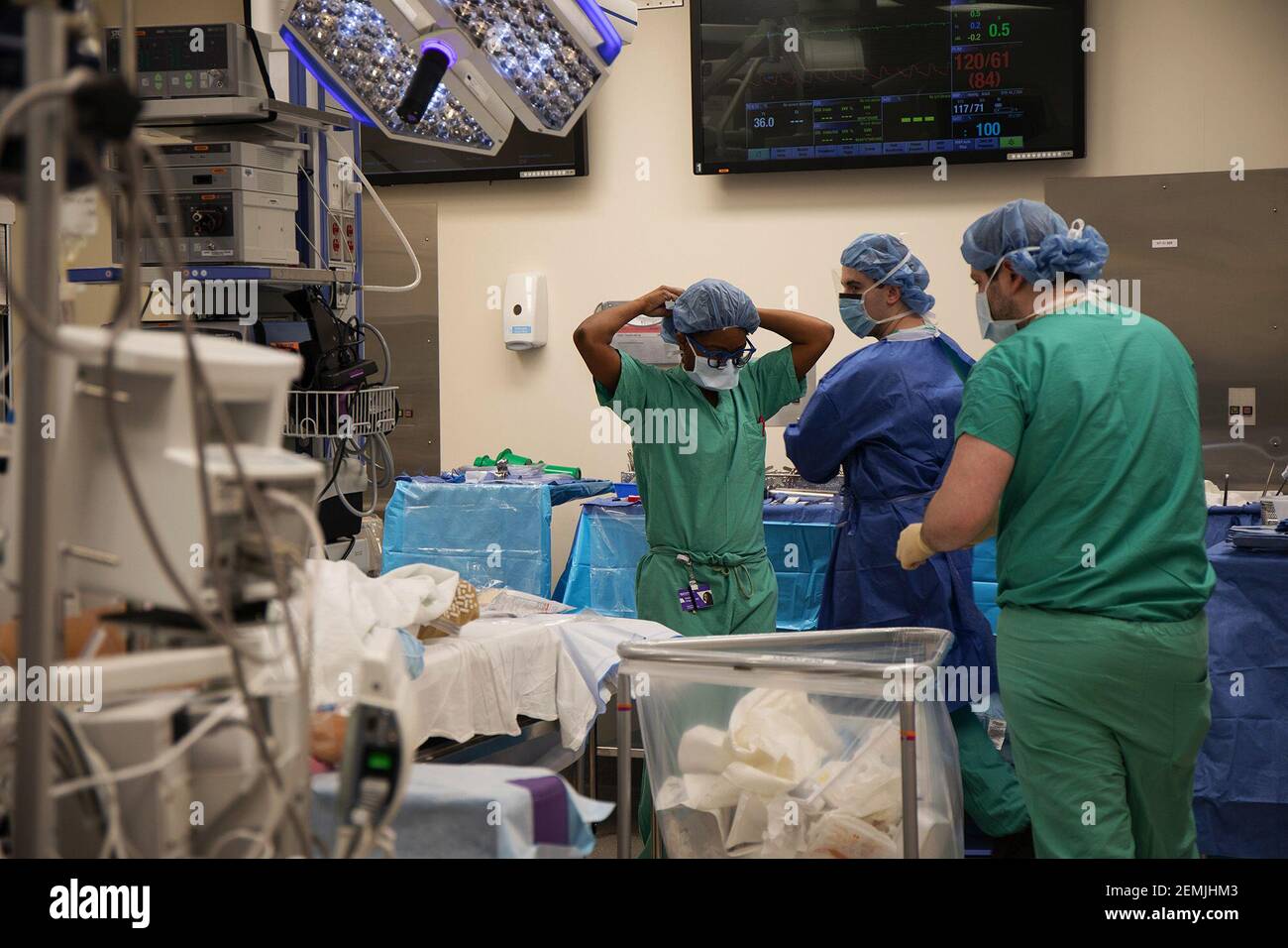 Dr. Dinee Simpson, left, prepares for kidney transplant surgery at ...
