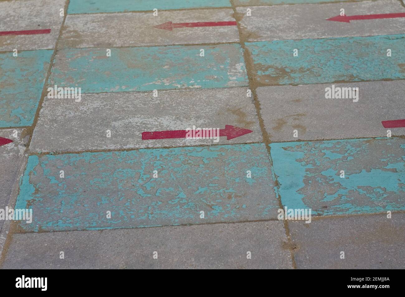 Two red directional arrows painted on a walkway of a bathhouse (Pesaro ...