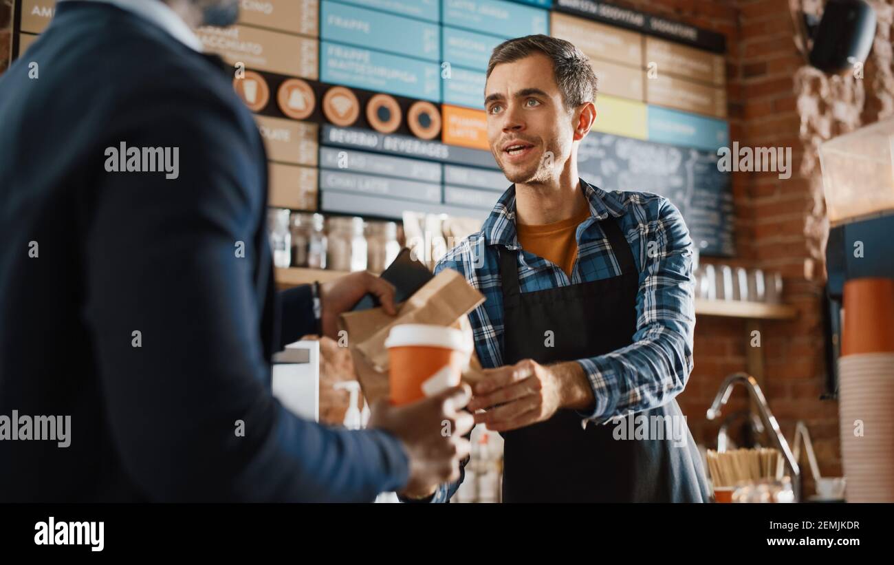 Handsome Barista in Blue Checkered Shirt Passes Coffe and Paper Bag ...