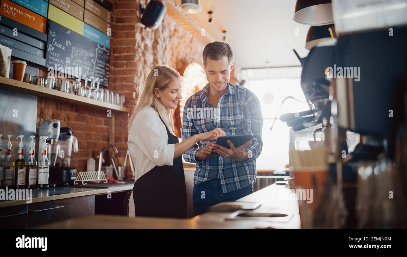 Two Diverse Entrepreneurs Have a Team Meeting in Their Stylish Coffee ...