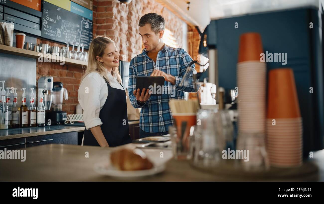 Two Diverse Entrepreneurs Have a Team Meeting in Their Stylish Coffee ...
