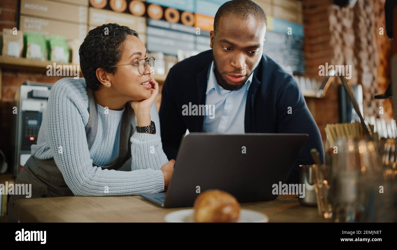 Two Diverse Entrepreneurs Have a Team Meeting in Their Stylish Coffee ...