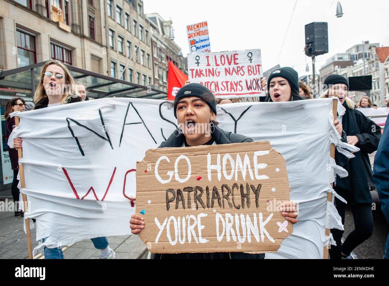 Protesters are seen chanting slogans while holding a banner and ...