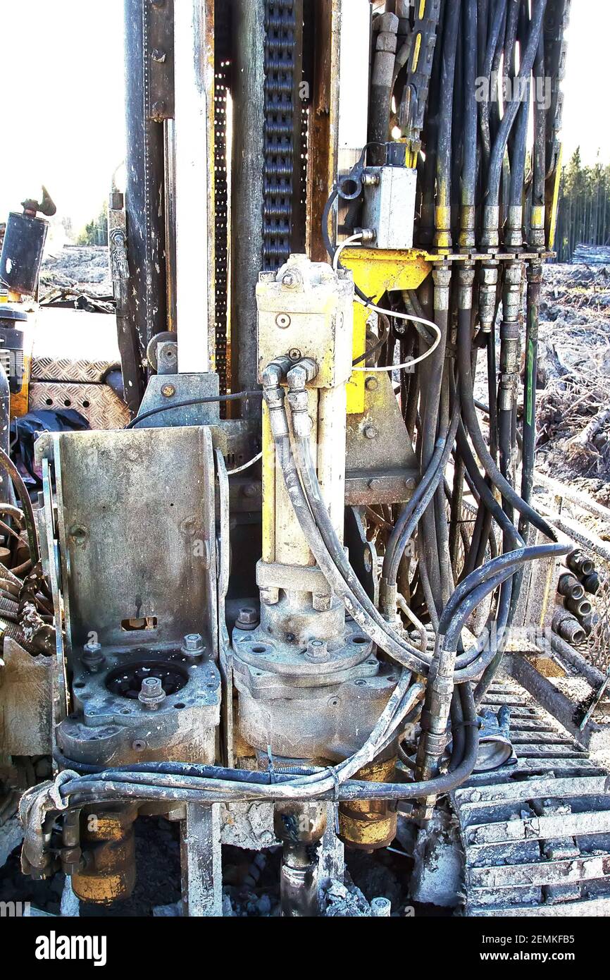 Mini-drilling rig on crawler track on site of sawn forest where large ...