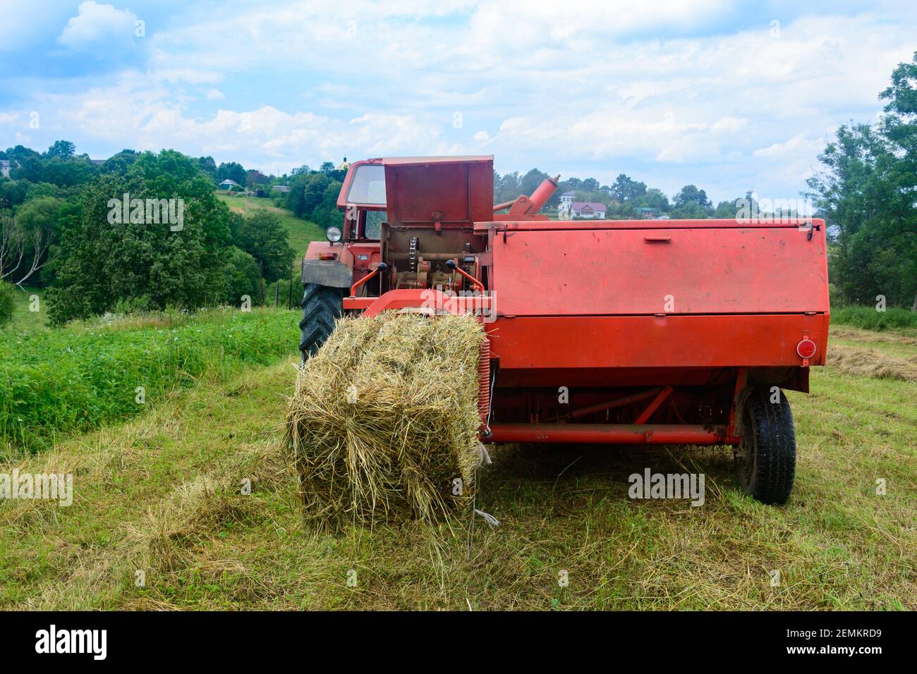 Pressing hay into bales, old working press, harvesting and harvesting ...