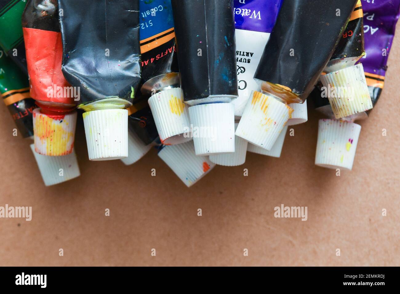Tubes of art paint with variety of colours on paper background Stock ...