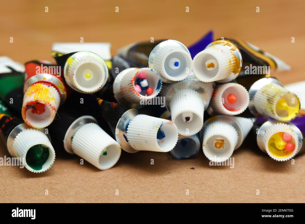Tubes of art paint with variety of colours on paper background Stock ...