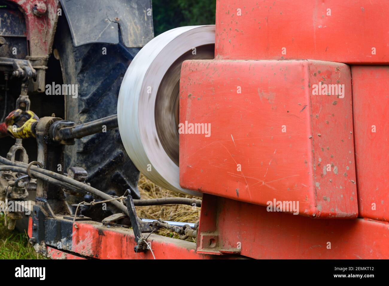 The process of pressing hay into bales, the work of the press machine ...