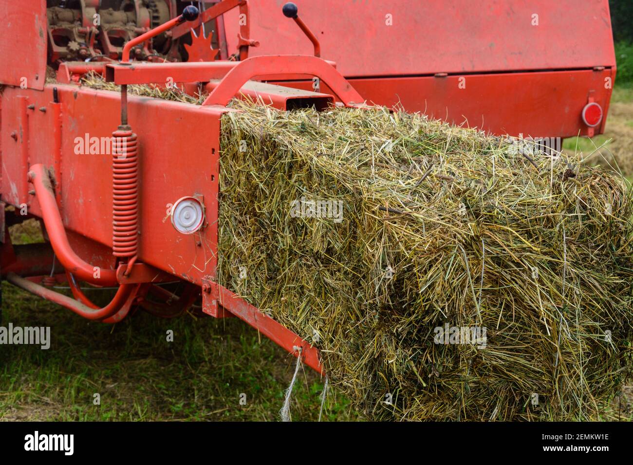 Pressing hay into bales, old working press, harvesting and harvesting ...
