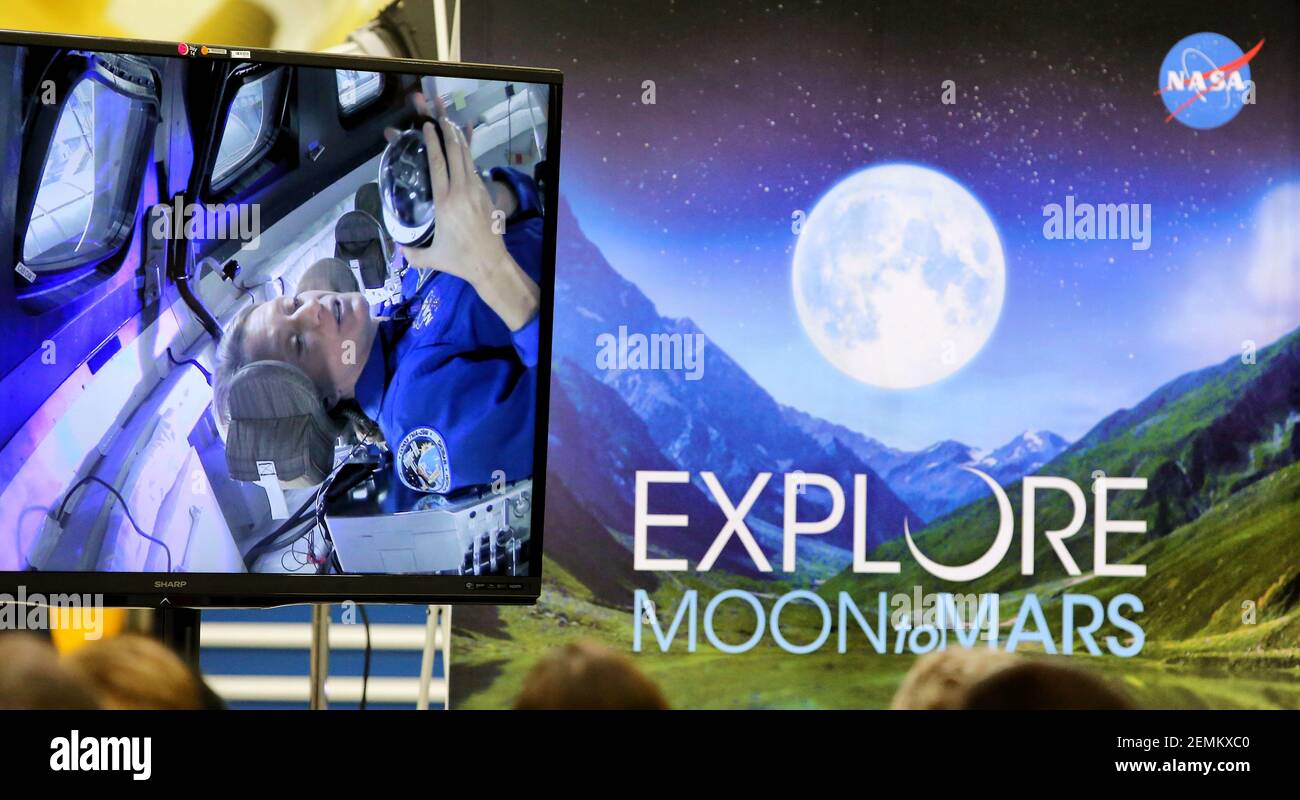 Sitting inside a prototype of the Orion capsule, NASA astronaut Karen ...