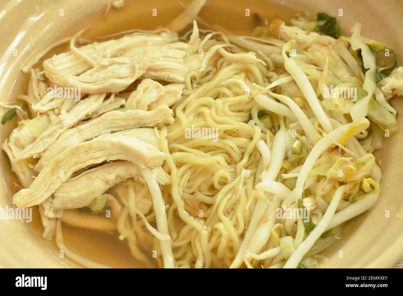 chinese yellow egg noodles topping slice boiled chicken in soup on bowl ...