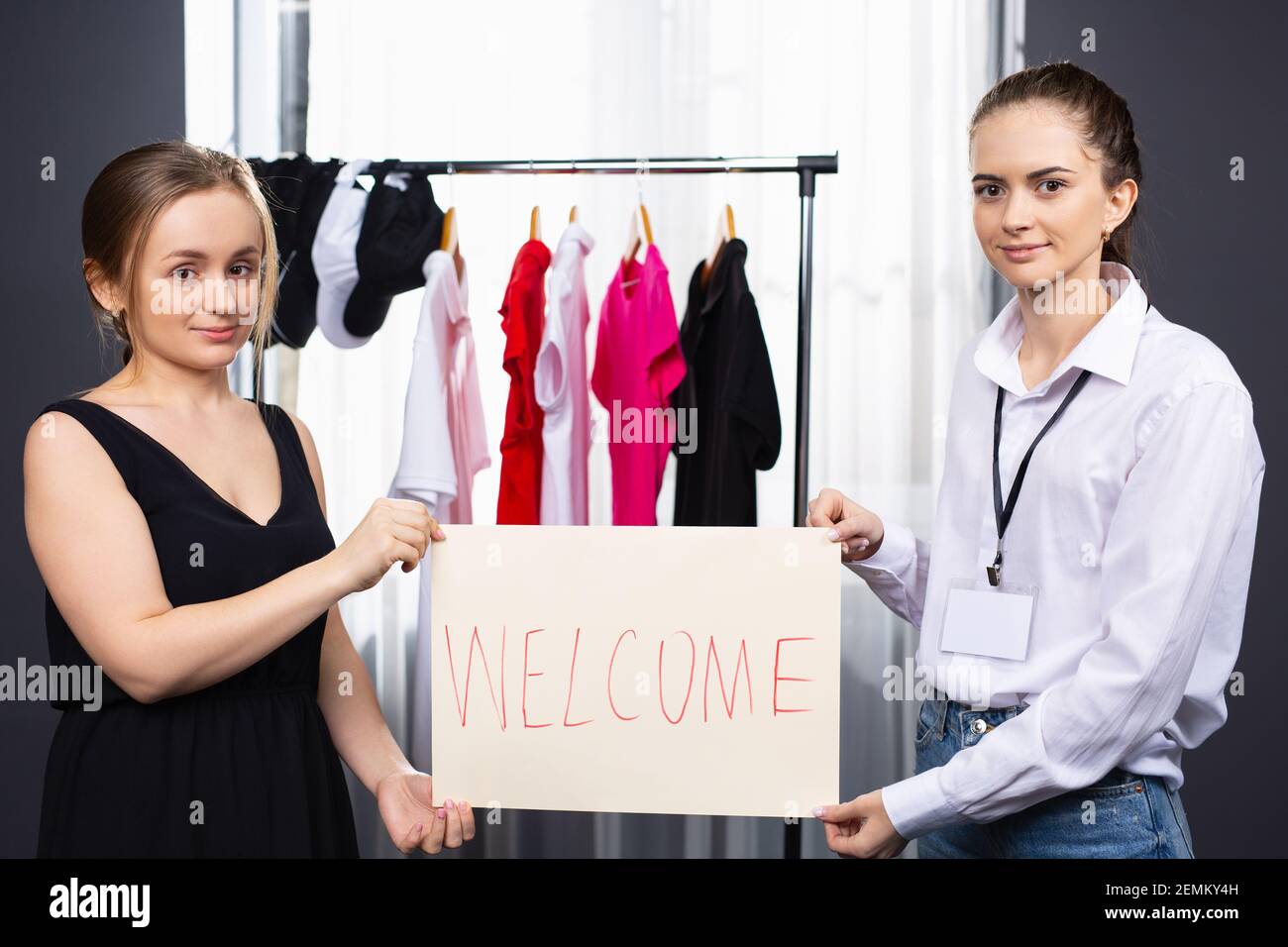 Two beautiful young caucasian fashion shop owners at their boutique ...