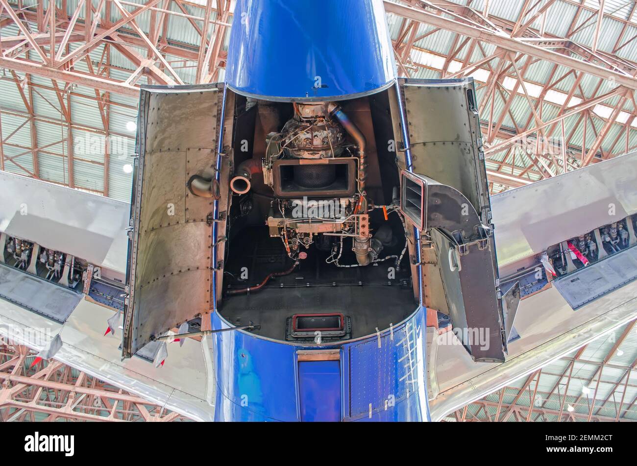 Auxiliary power plant in the tail of the aircraft with open hood covers ...