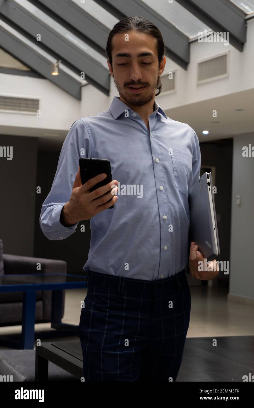 vertical photo man very upright in his posture using his smart phone ...