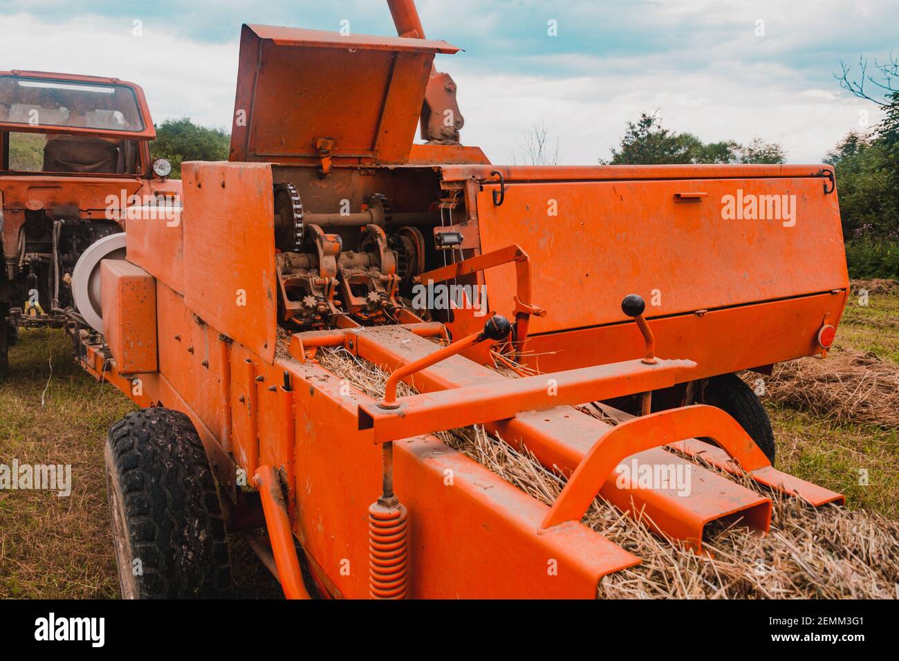 The process of pressing hay into bales, the work of the press machine ...