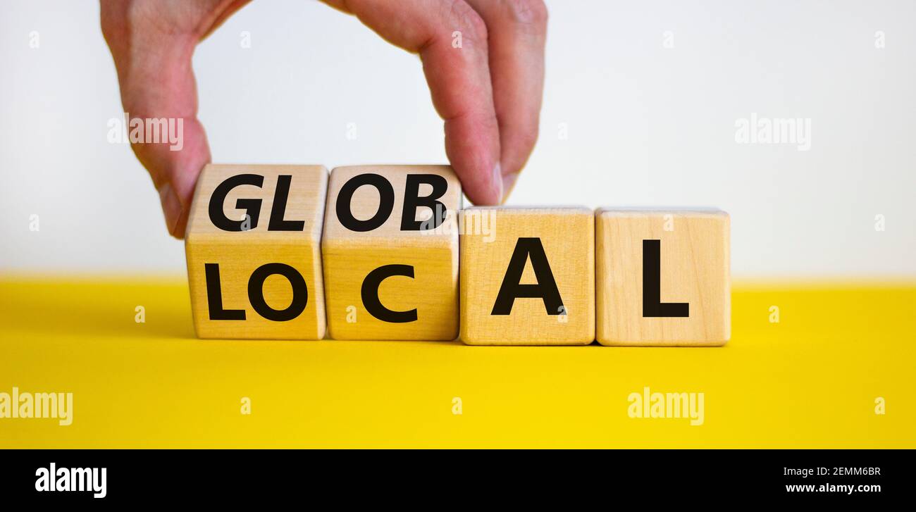 Local or global symbol. Businessman turns wooden cubes and changes the ...
