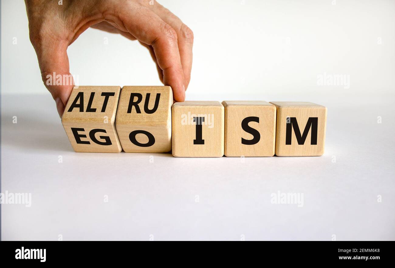 Altruism or egoism symbol. Businessman turns wooden cubes and changes ...