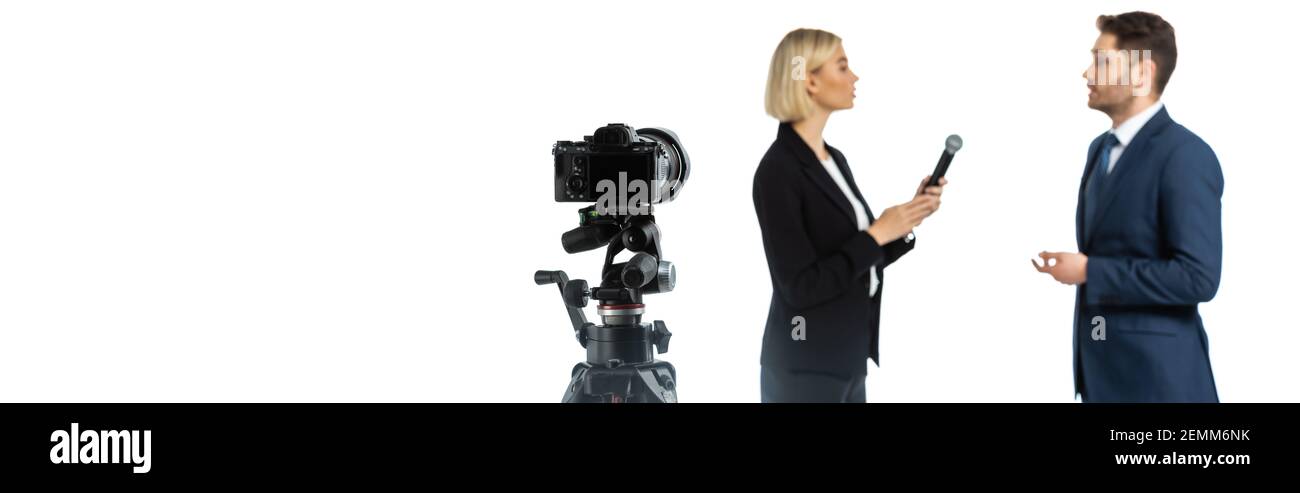 side view of blonde journalist interviewing young businessman isolated ...