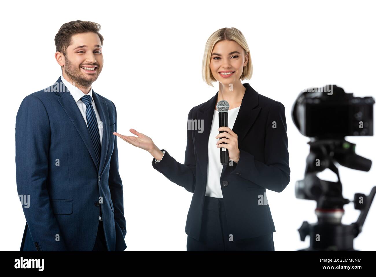 smiling news anchor pointing at happy businessman during interview near ...
