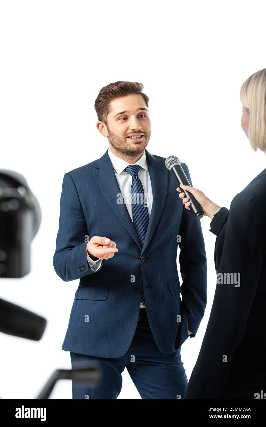 smiling businessman pointing with finger during interview with ...