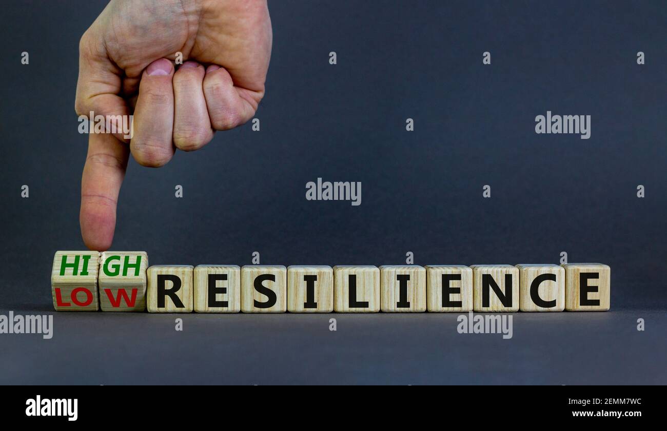 High or low resilience symbol. Businessman hand turns cubes and changes ...