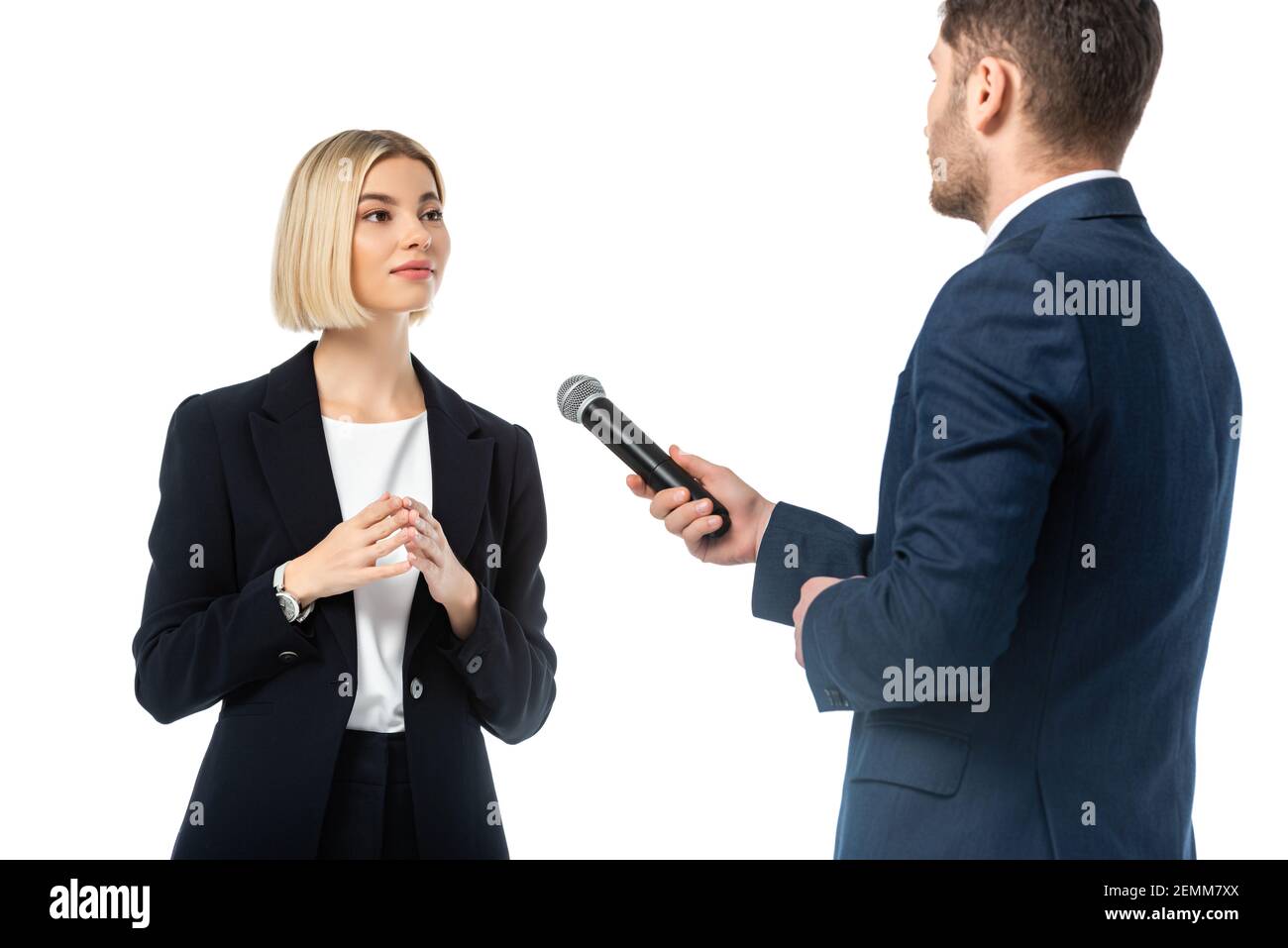 news anchor with microphone taking interview from young blonde ...