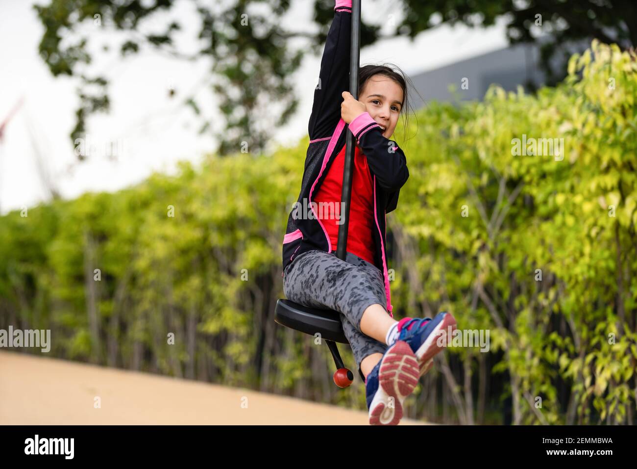 The little girl on the bungee jumping for kids outdoor Stock Photo - Alamy