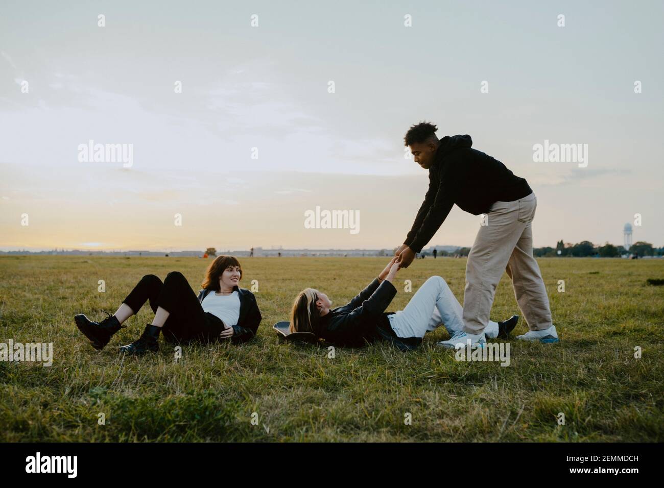 Three women laying down grass hi-res stock photography and images - Alamy