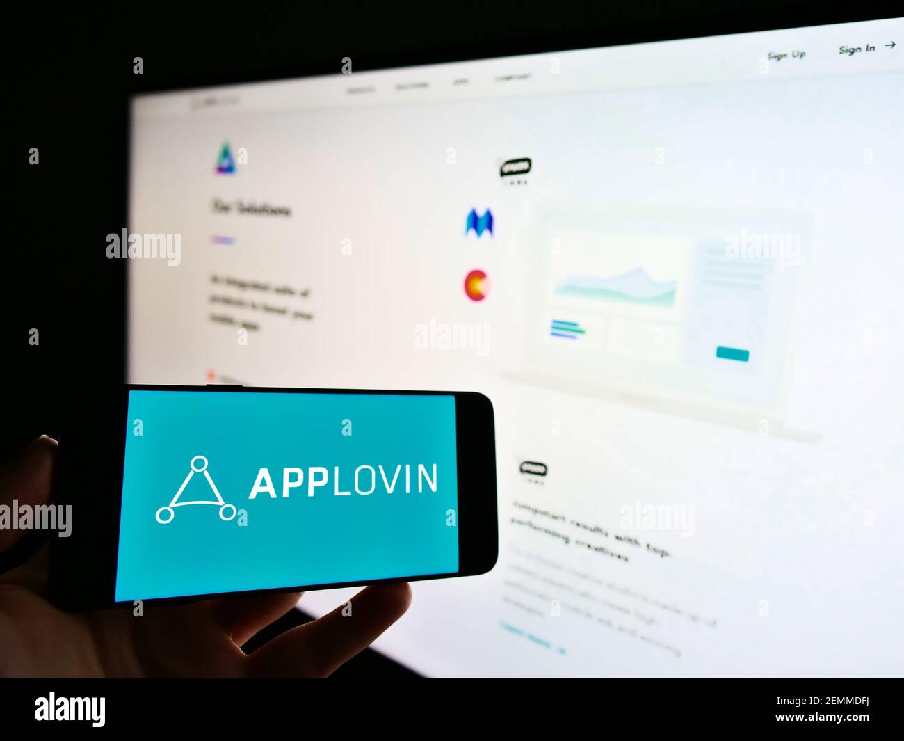 Person holding cellphone with company logo of US mobile technology ...
