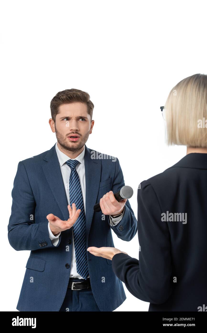 discouraged journalist with microphone gesturing near blonde ...