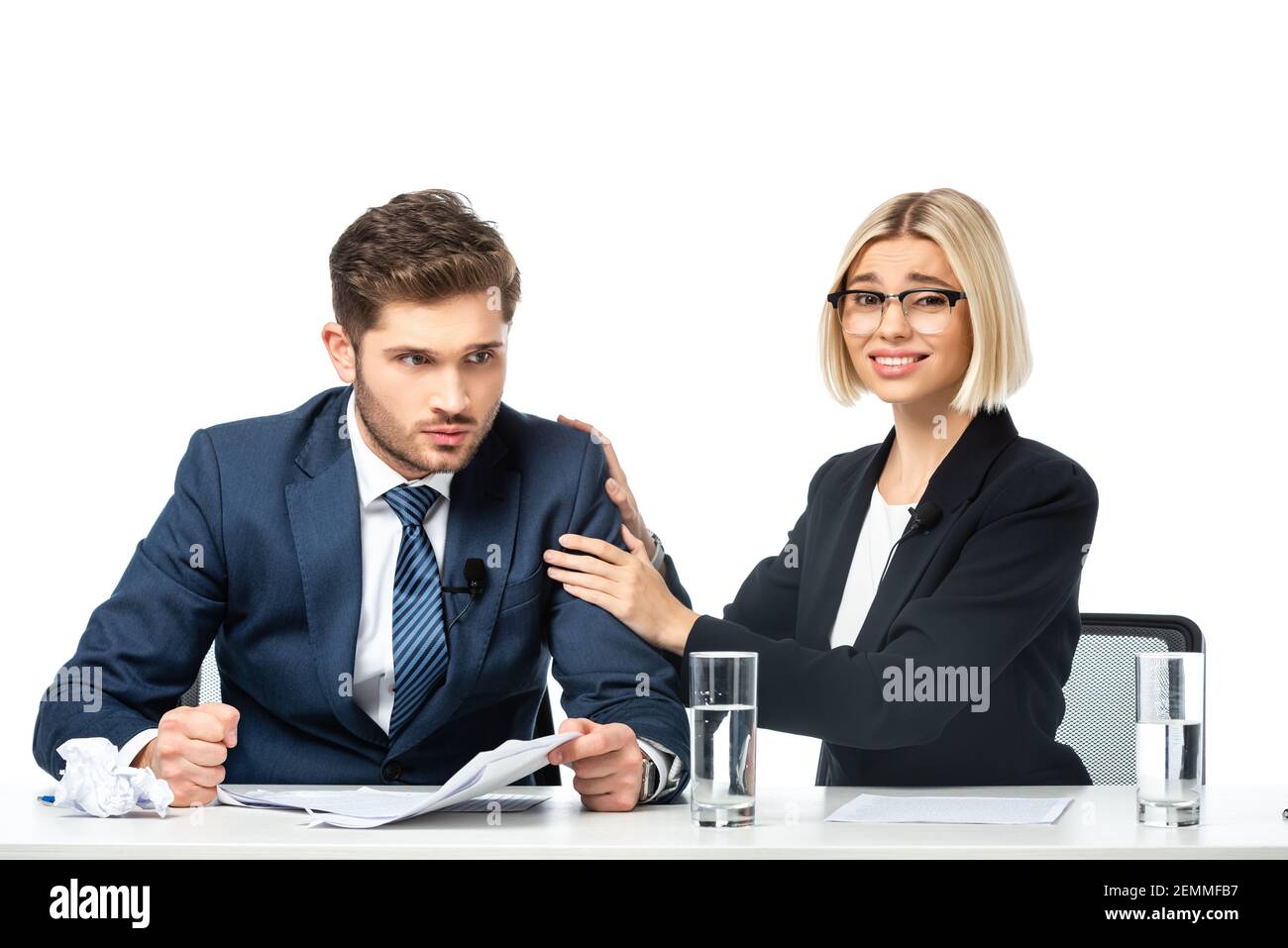 young blonde colleague calming angry colleague at workplace isolated on ...