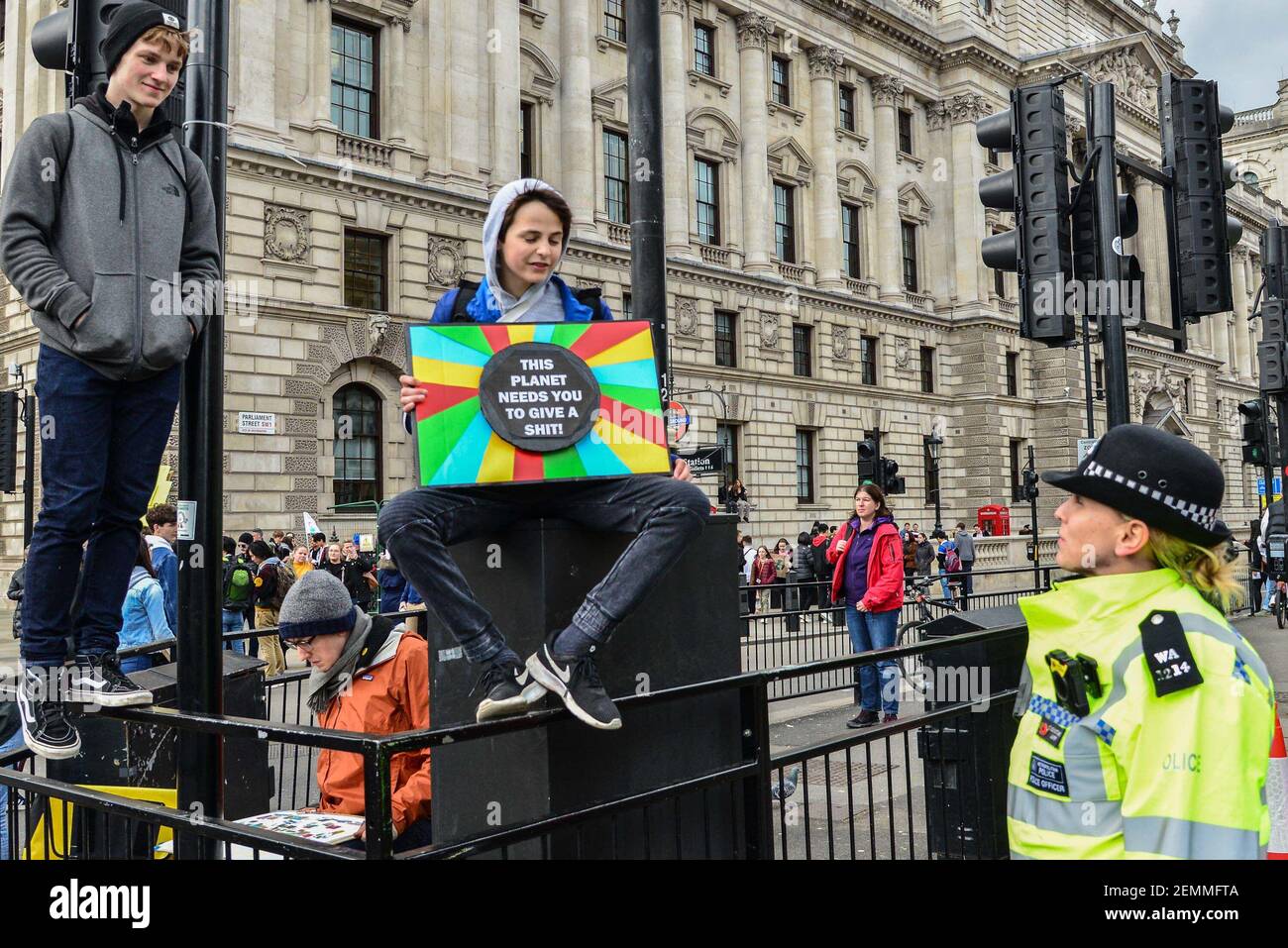 Student climate change activists speak with a police officer in ...