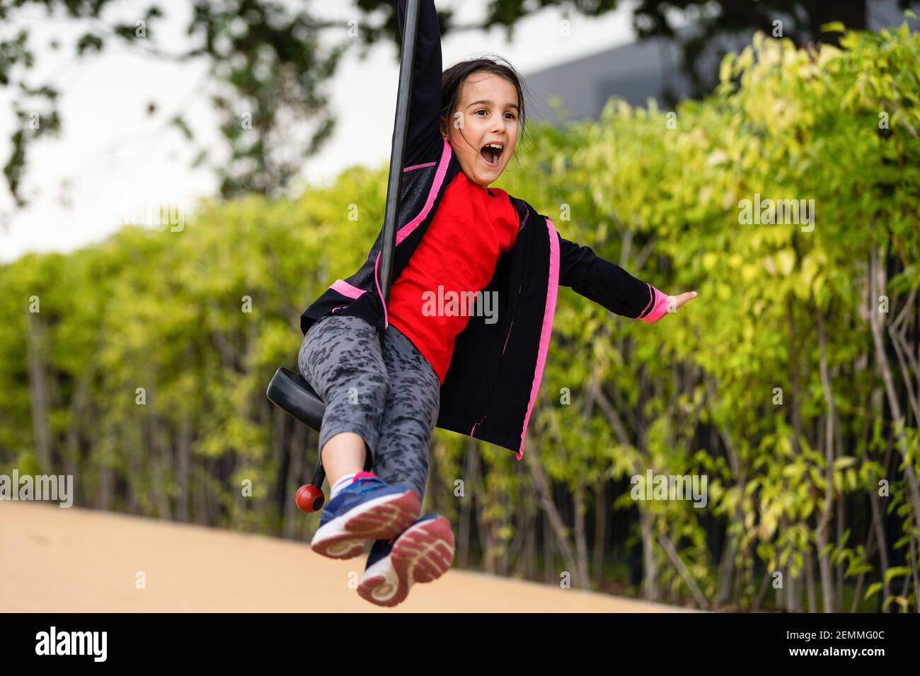 The little girl on the bungee jumping for kids outdoor Stock Photo - Alamy