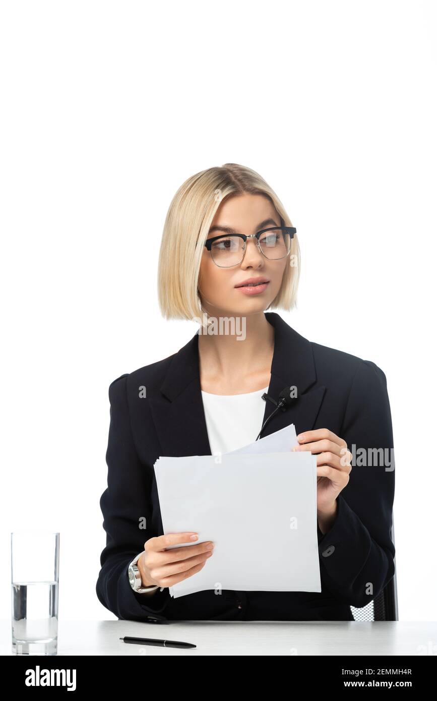 young blonde news presenter holding papers at workplace isolated on ...