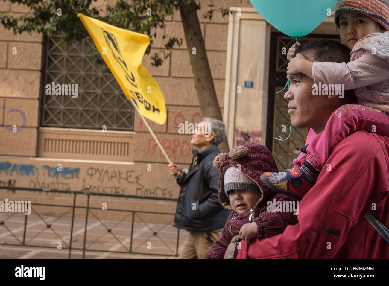 A father with his children are seen during the demonstration. Thousands ...